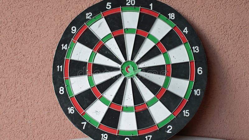 Green Dart Arrow Hitting in the Target Center of Dartboard with Post ...
