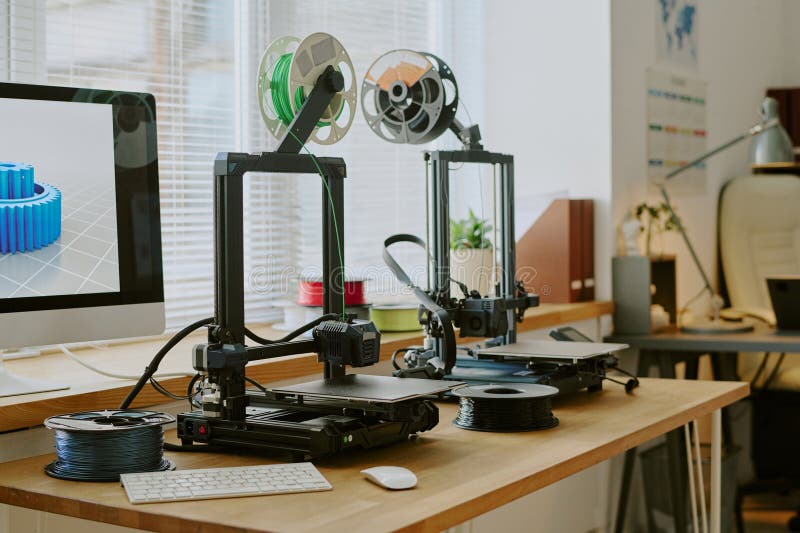 3D Printing Machines on Office Desk Near Computer Screen Stock Photo ...