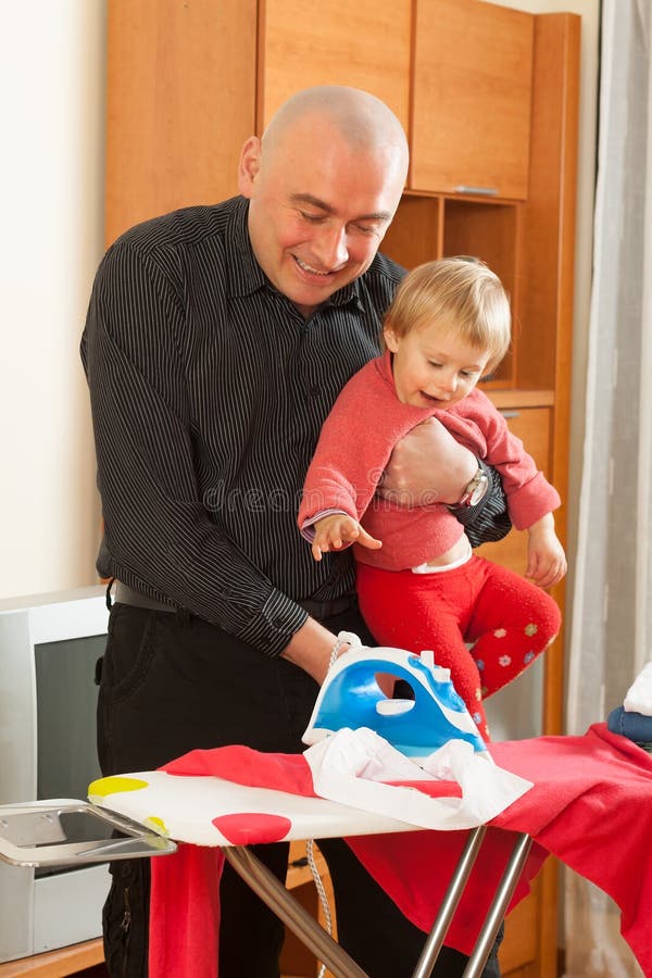 Dad with baby ironing stock image. Image of life, parent - 48087433