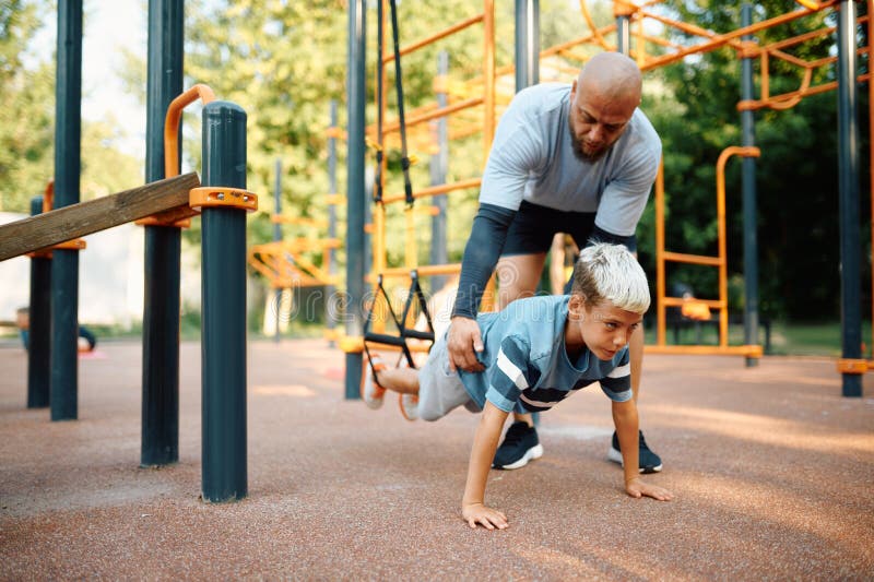Dad and Boy Doing Exercise with Ropes Outdoors Stock Image - Image of ...