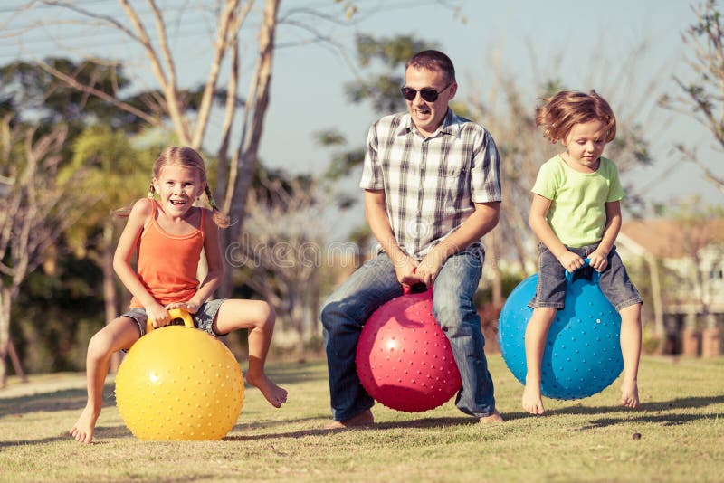 Dad and Children Playing on the Lawn in Front of House Stock Photo ...