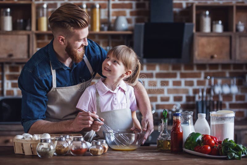 Dad and daughter cooking stock photo. Image of female - 295606460