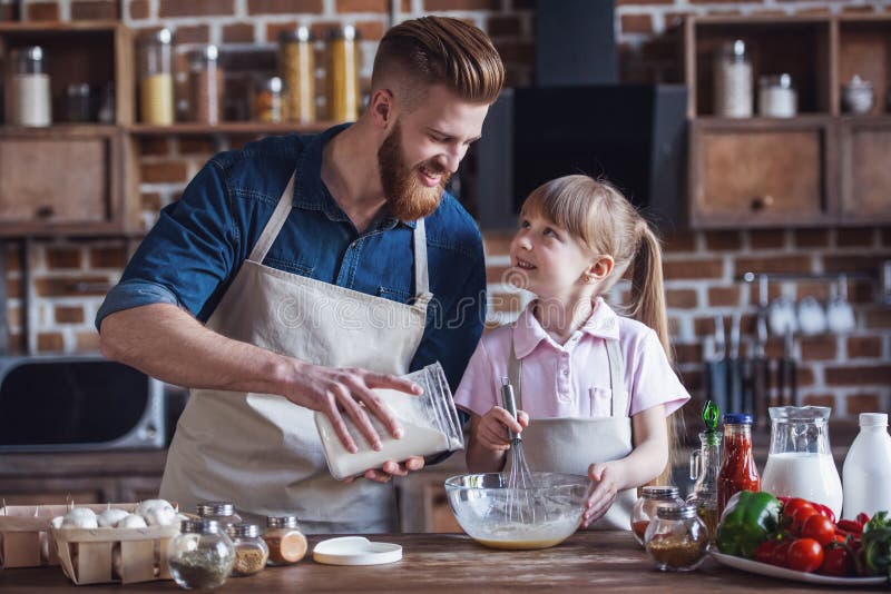Dad and daughter cooking stock photo. Image of flour - 295606550