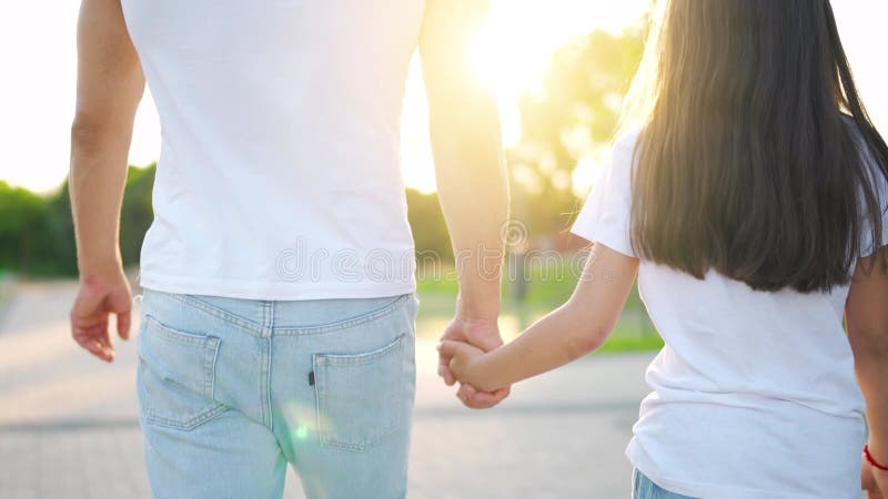 Dad and Daughter Walk Around Their Area at Sunset. Back View. Slow ...