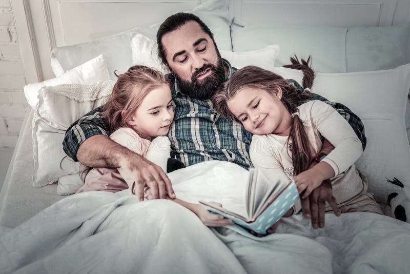 Dad and Daughters Cuddling in Bed Reading Book Stock Image - Image of ...