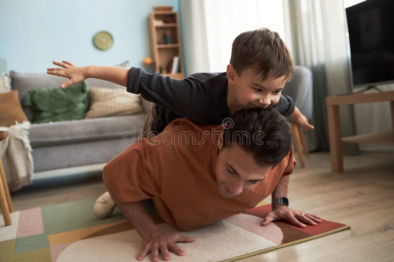 Dad Doing Exercises with His Son Stock Photo - Image of playful, father ...