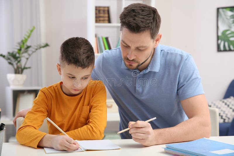 Dad Helping His Son with Homework Stock Image - Image of book, mature ...