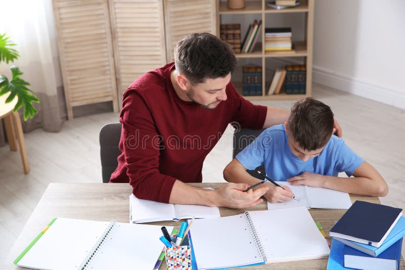 Dad Helping His Son with Homework Stock Photo - Image of male, parent ...