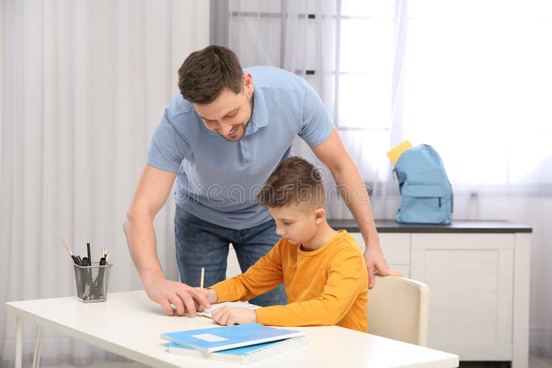 Dad Helping His Son with Homework Stock Photo - Image of family ...