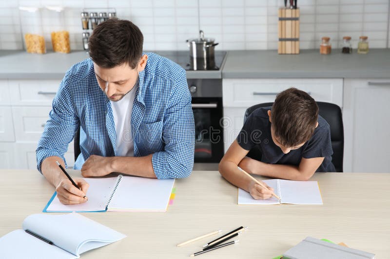 Dad Helping His Son with Homework Stock Photo - Image of home, parent ...