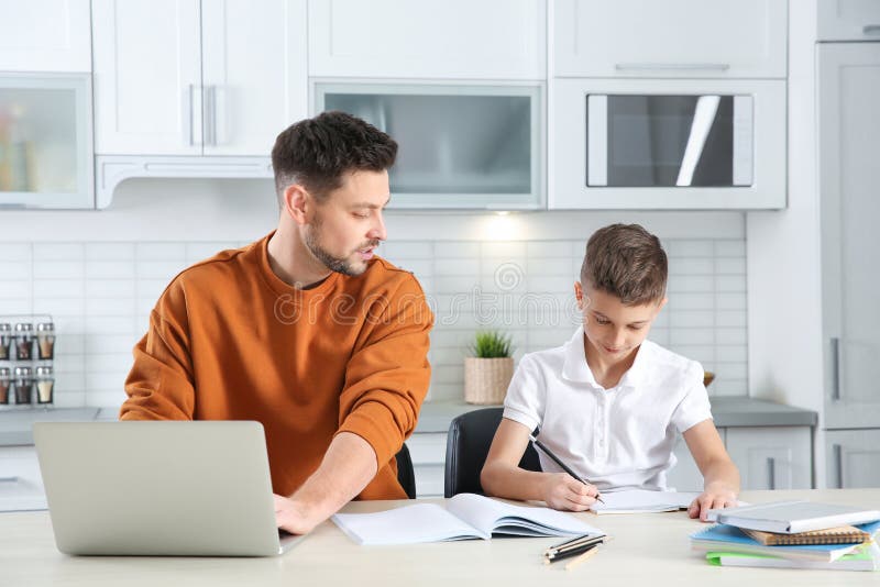 Dad Helping His Son with Homework Stock Image - Image of notebook ...