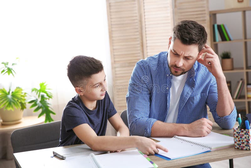 Dad Helping His Son with Homework Stock Image - Image of help, adult ...