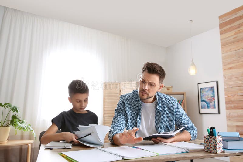 Dad Helping His Son with Homework Stock Photo - Image of preteen ...