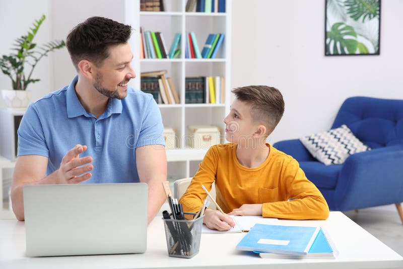 Dad Helping His Son with Homework Stock Photo - Image of notebook ...