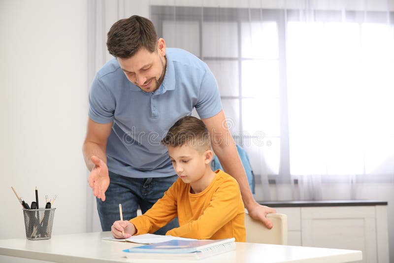 Dad Helping His Son with Homework in Room Stock Image - Image of ...