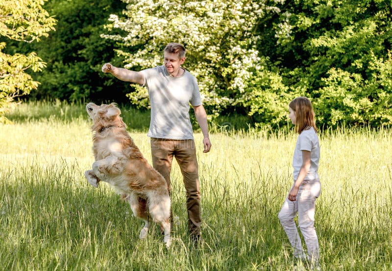 Dad and His Daugter Play with Dog Stock Photo - Image of caucasian ...