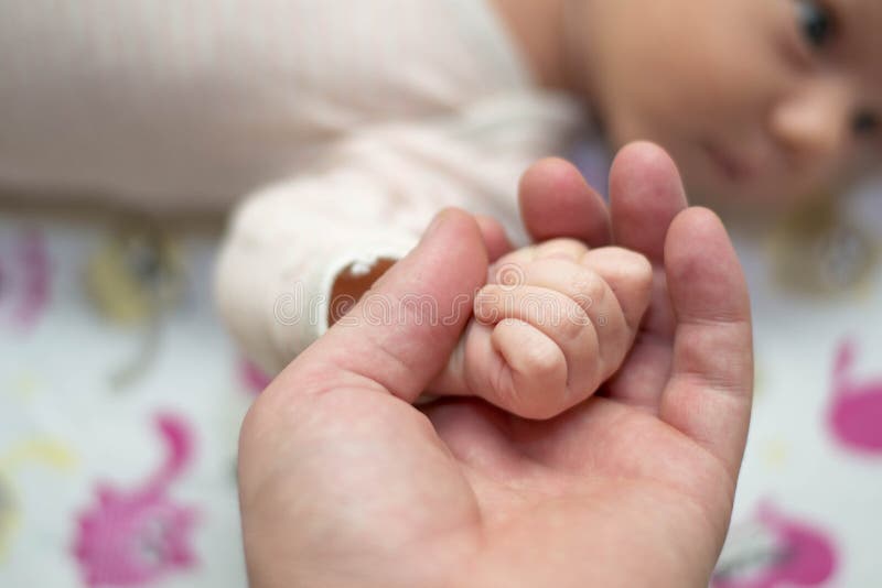 Dad is Holding the Hand of His Newborn Baby Stock Image - Image of ...