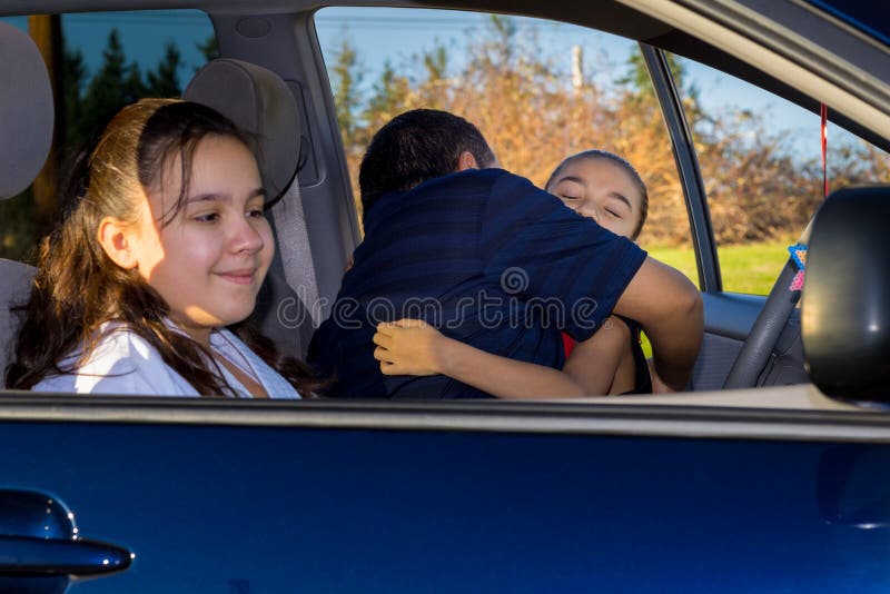 Dad Hugs Daughter at Car stock image. Image of activities - 49573543