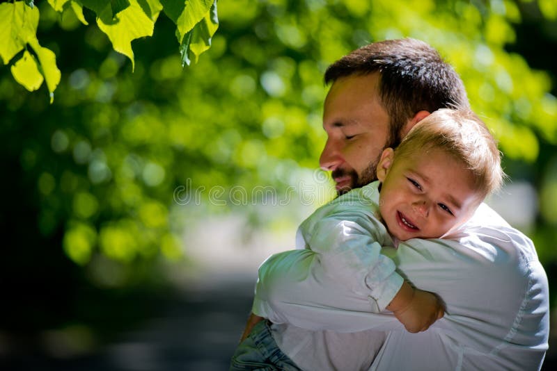Dad Hugs His Little Son in the Park. Stock Photo - Image of nature ...