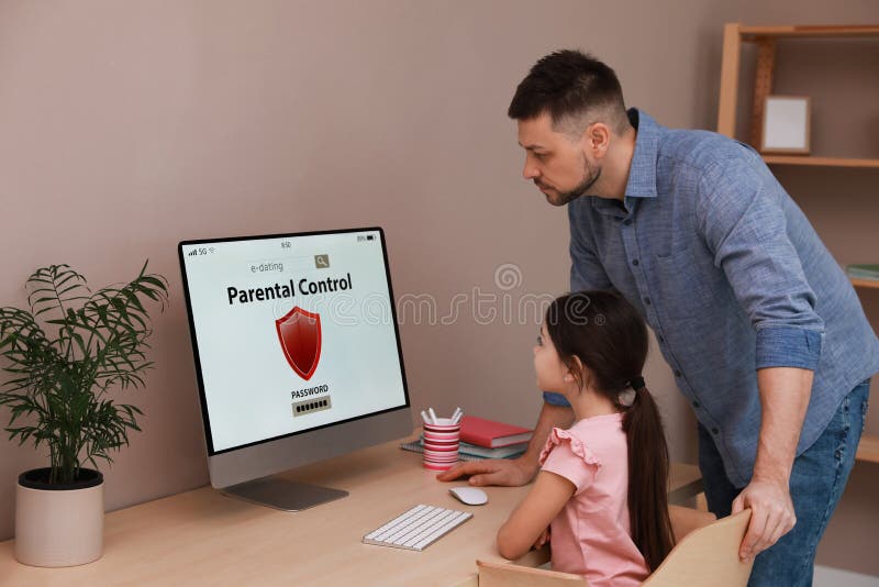 Dad Installing Parental Control on Computer at Table. Child Safety ...