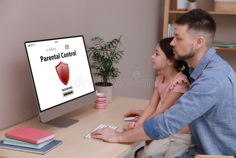 Dad Installing Parental Control on Computer at Table. Child Safety ...