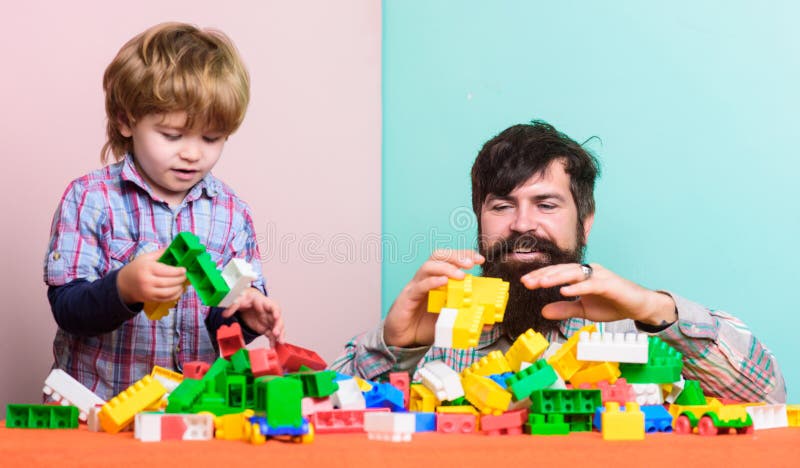 Dad and Kid Build of Plastic Blocks. Father and Son Create Colorful ...