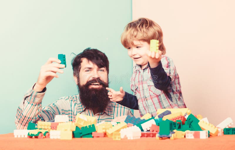 Dad and Kid Build of Plastic Blocks. Father and Son Create Colorful ...