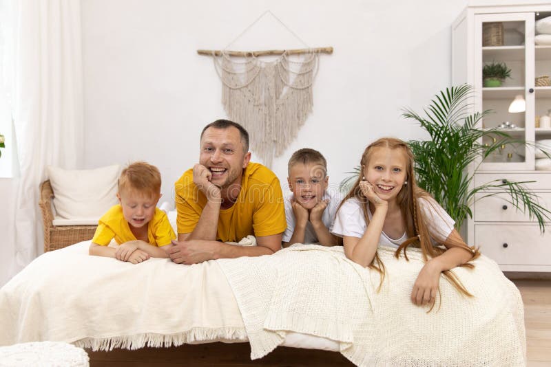 Dad with the Kids on the Bed. Dad Stayed at Home with Children Stock ...