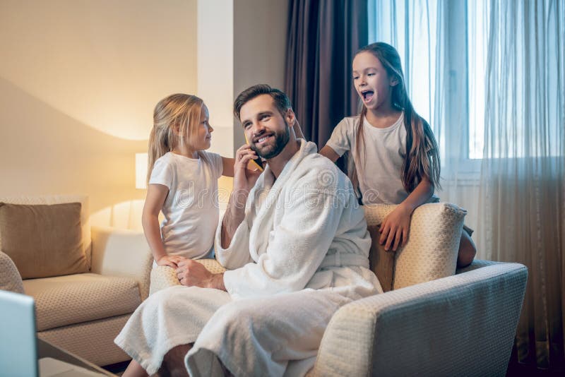 Young Dad Working from Home and Spending Time with His Daughters Stock ...