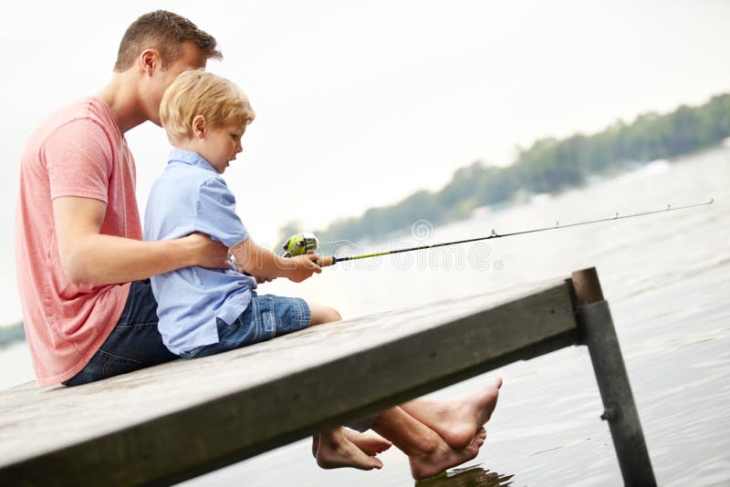 Dad Knows Everything. a Father Teaching His Son How To Fish Whilst ...