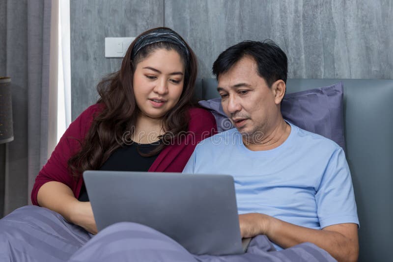 Dad and Mom Use Computer Notebook. Family Time Together at Home. Happy ...