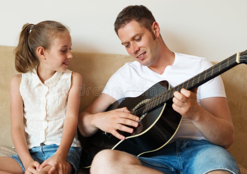 Dad plays the guitar. stock photo. Image of guitar, female - 101018588