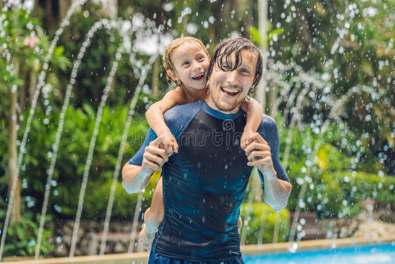 Dad and Son Have Fun in the Pool Stock Photo - Image of drop, caucasian ...