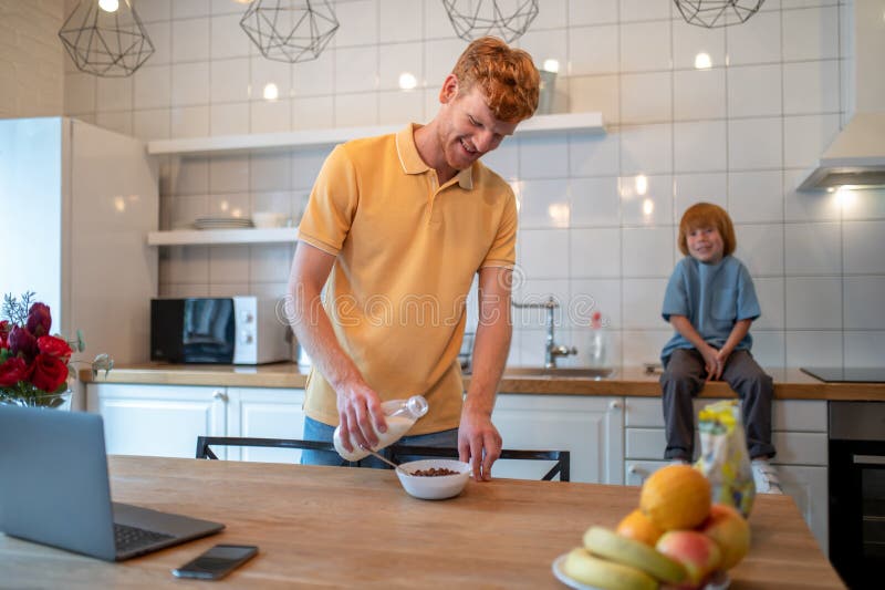 Ginger Man with a Bottle of Milk in Hands Getting Ready the Breakfast ...