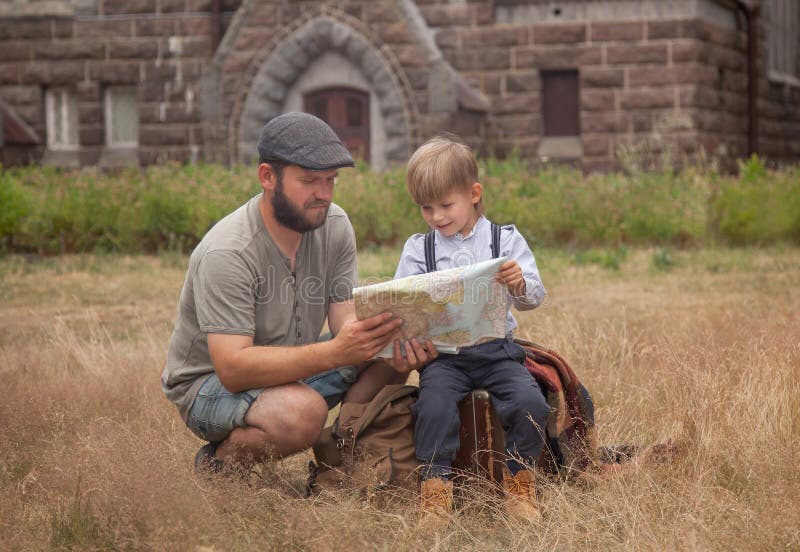 Dad and Son are Looking at the Route on the Map Stock Image - Image of ...
