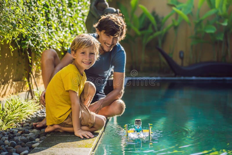 Dad and Son Playing with a Boat in the Pool Stock Photo - Image of ...