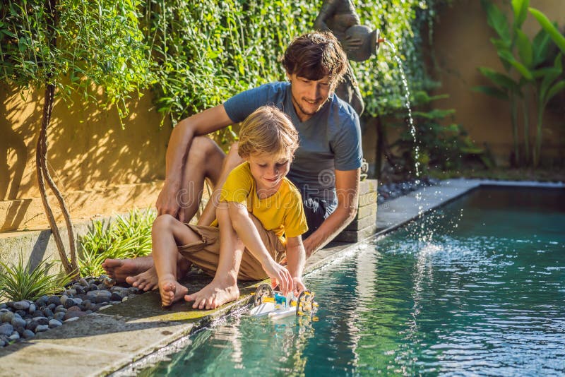 Dad and Son Playing with a Boat in the Pool Stock Image - Image of ...