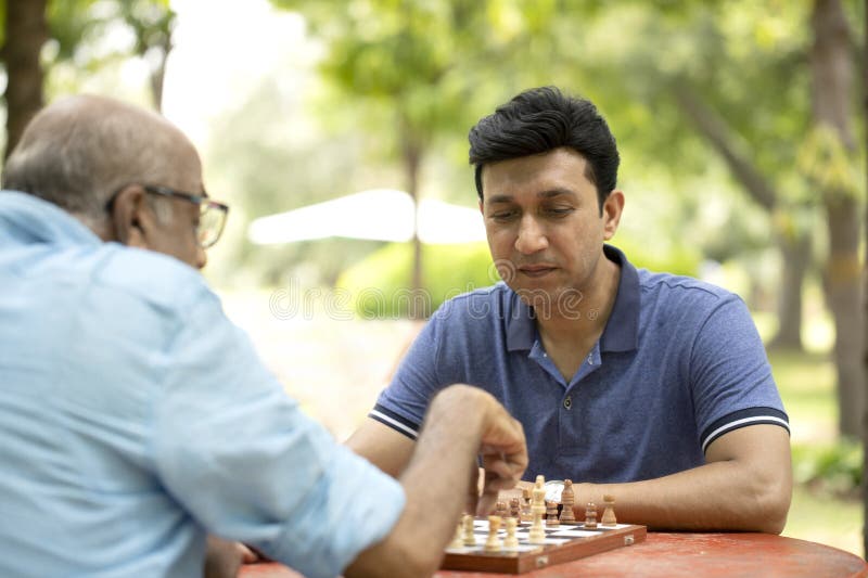Dad and Son Playing Chess stock image. Image of play - 371572285
