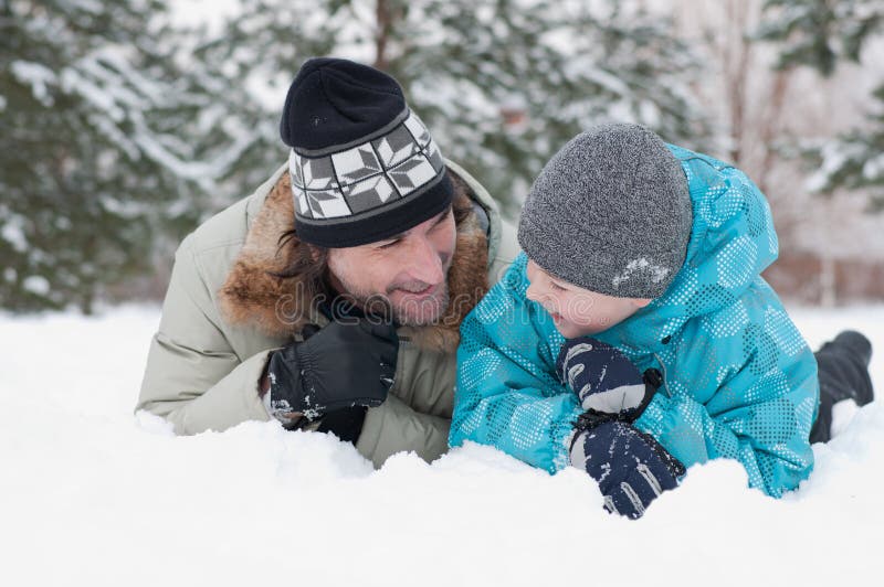 Dad and Son Rest in the Snow Stock Image - Image of trees, child: 22922859