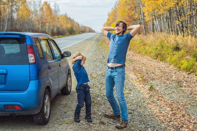 Dad and Son are Resting on the Side of the Road on a Road Trip. Road ...