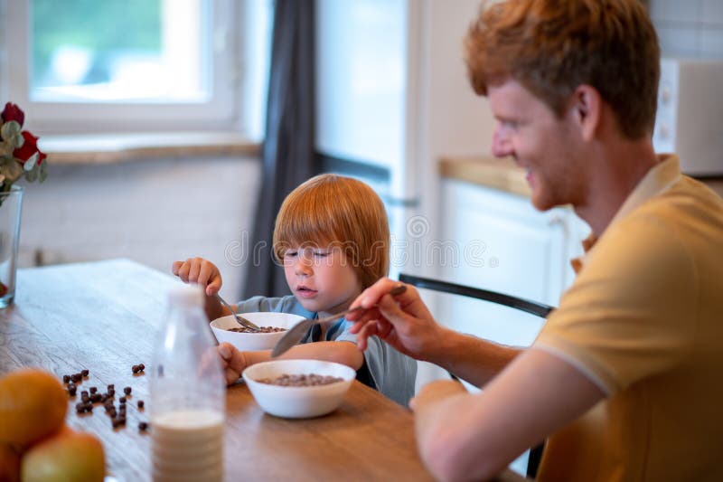 Dad and Son Sitting at the Table and Eating Breakfast Stock Image ...