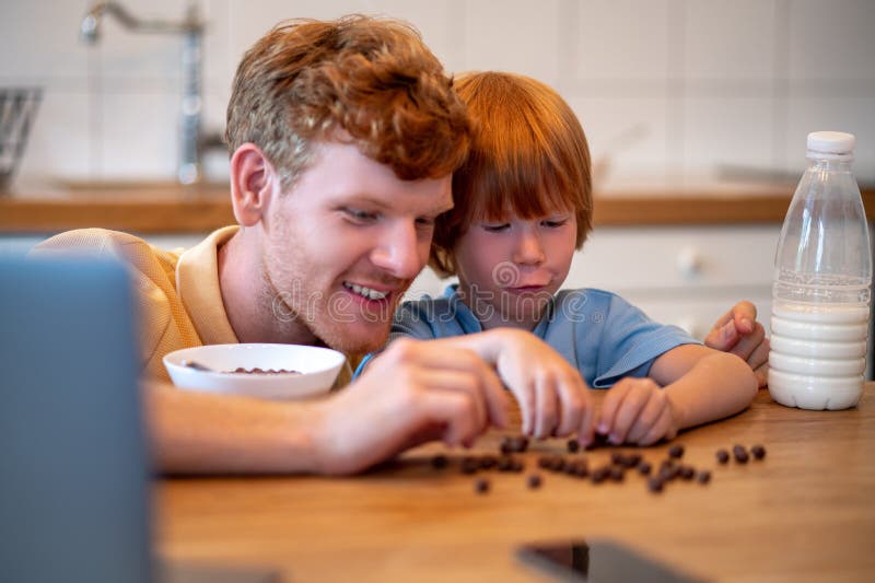 Dad and Son Sitting at the Table and Eating Breakfast Stock Image ...