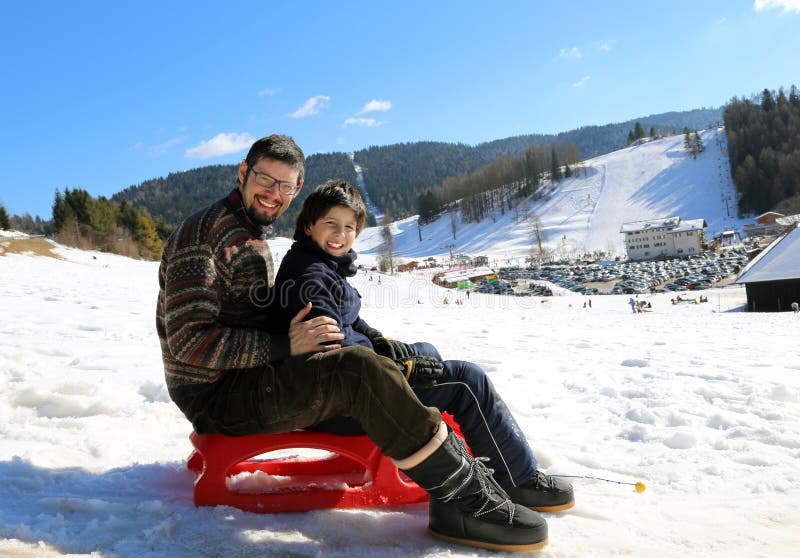 Dad with Son Sledding in Winter on the White Snow Stock Photo - Image ...