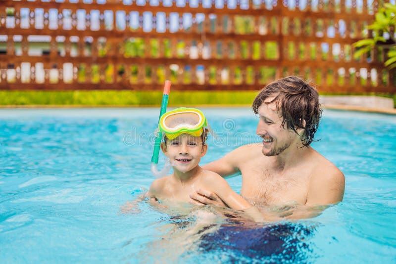 Dad and Son in Swimming Goggles Have Fun in the Pool Stock Photo ...