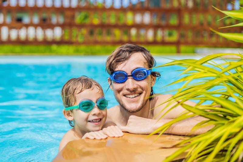 Dad and Son in Swimming Goggles Have Fun in the Pool Stock Image ...