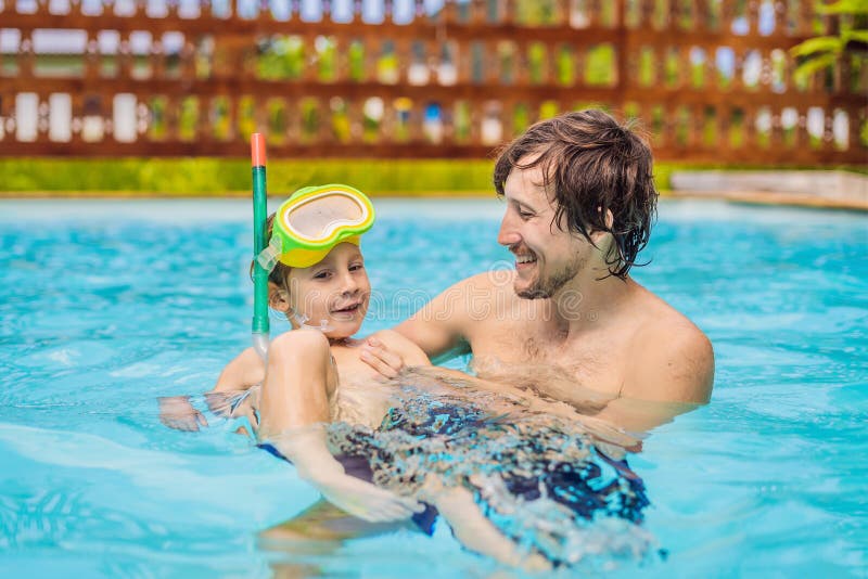 Dad and Son in Swimming Goggles Have Fun in the Pool Stock Photo ...