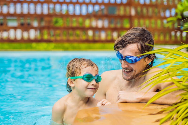 Dad and Son in Swimming Goggles Have Fun in the Pool Stock Photo ...