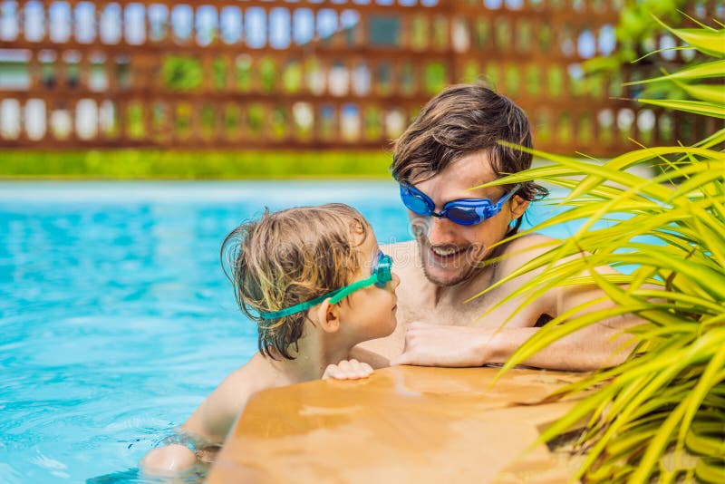 Dad and Son in Swimming Goggles Have Fun in the Pool Stock Image ...