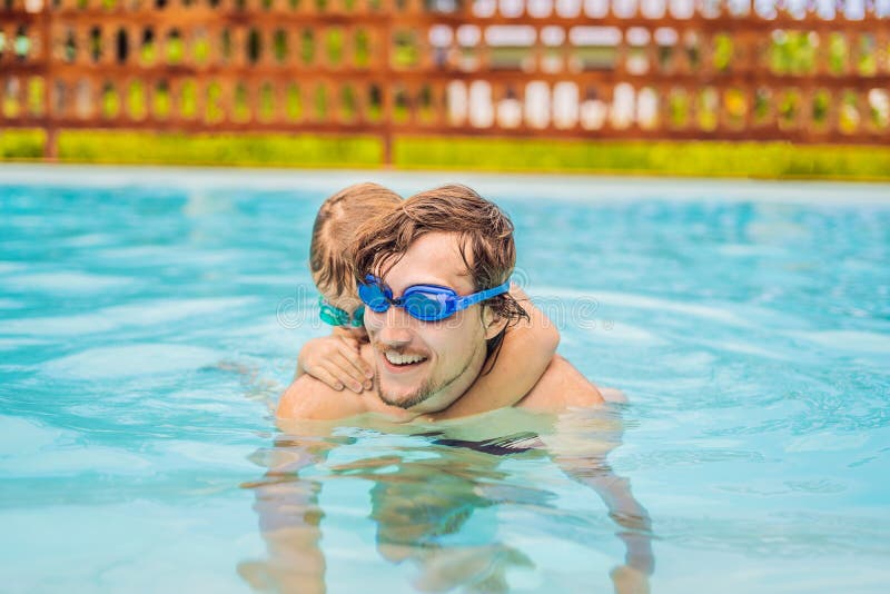 Dad and Son in Swimming Goggles Have Fun in the Pool Stock Photo ...