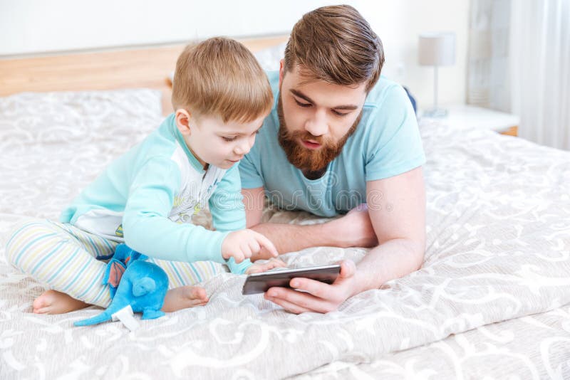 Dad and Son Using Mobile Phone Together Stock Photo - Image of daddy ...